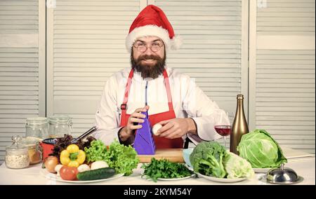 Man bearded chef wear santa claus hat cooking. How to enjoy holiday ...