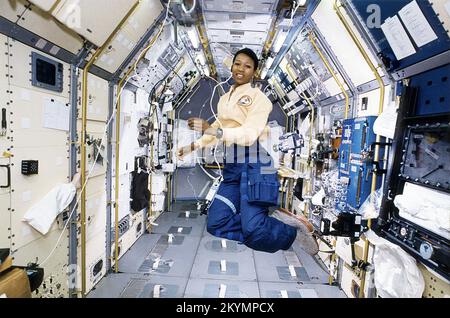 NASA Mission Specialist Mae Jemison looks out the window of the aft ...