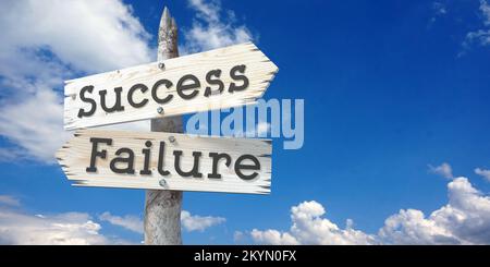 Success and failure - wooden signpost with two arrows Stock Photo - Alamy