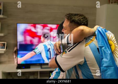 Argentinian fans hug eachother celebrating Messi's goal against Mexico ...