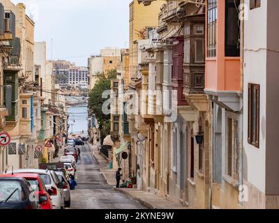 Sliema, Malta - May, 2021: Narrow street and historic sand-colored ...