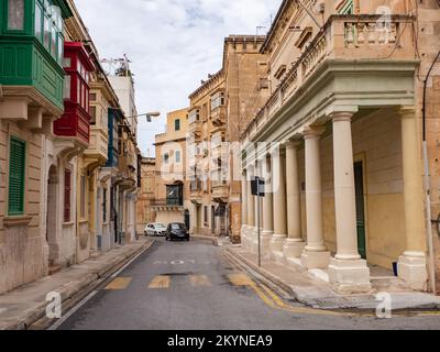 Sliema, Malta - May, 2021: Narrow street and historic sand-colored ...
