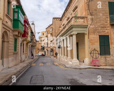 Sliema, Malta - May, 2021: Narrow street and historic sand-colored ...