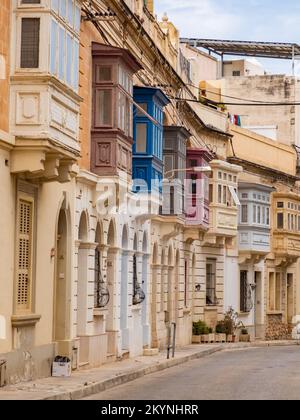 Sliema, Malta - May, 2021: Narrow street and historic sand-colored ...
