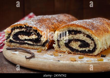 Homemade poppy seed strudel on wooden board. Cut across. Sweet Poppy ...