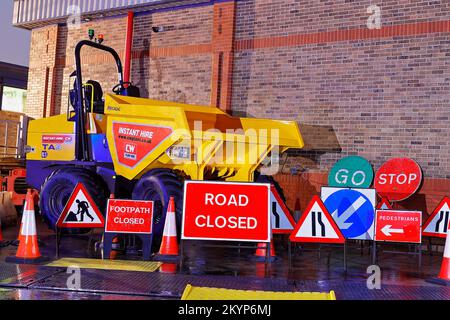 A 9 tonne forward tipping dump truck and road signs at a plant hire ...