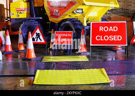 A 9 tonne forward tipping dump truck and road signs at a plant hire ...
