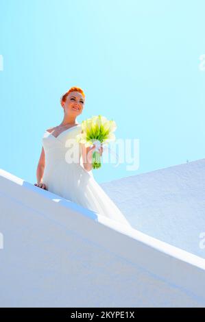 Pretty woman in white wedding dress on Santorini Stock Photo - Alamy