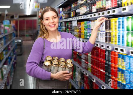 Young female customer selecting beer Stock Photo - Alamy