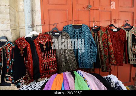 Traditional Palestinian clothes displayed for tourist at a souvenir ...