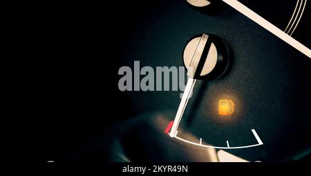 Low fuel indicator light on car dashboard with copy space below on ...