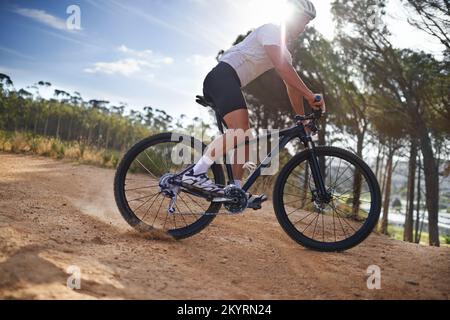 Nothing beats an extreme bike ride. Fit cyclist riding across rough ...