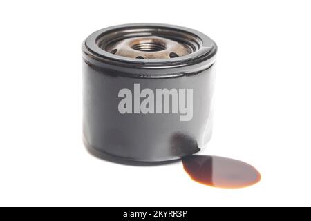 Car oil filter with a puddle of engine oil isolated on white background ...