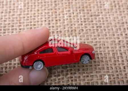 Colorful little toy car in hand on white background Stock Photo - Alamy