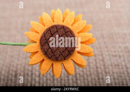 Fake flower placed on brown background Stock Photo - Alamy