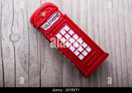Red telepphone booth on a grey background Stock Photo - Alamy