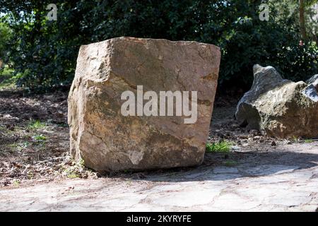 Big rock in garden by the side of a tree Stock Photo - Alamy