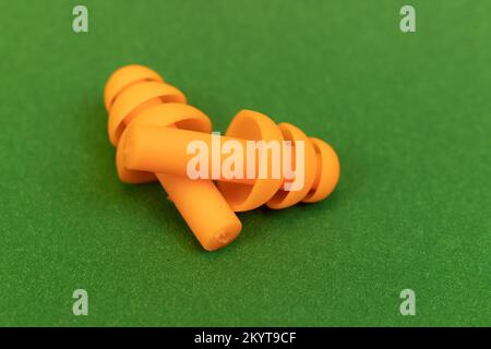 Silicone reusable ear plugs for human ears on green background Stock ...