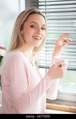 Beautiful woman are looking through jalousie, closeup Stock Photo - Alamy