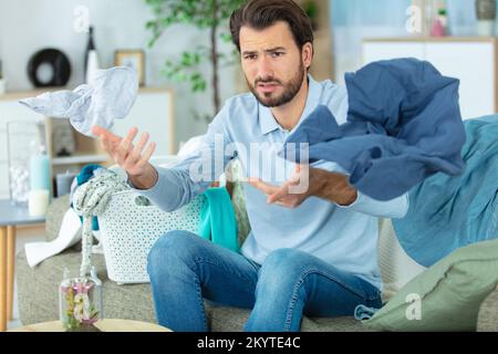 Young man husband doing clothing ironing at home Stock Photo - Alamy