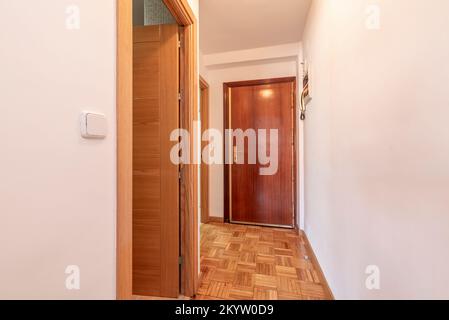 Hall of a house with armored door, parquet floors and oak doors with ...