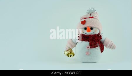 Handmade Cute snowman holding jingle bells on vertical white background ...