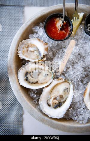 Oysters on the half shell marked with their farm location Stock Photo ...
