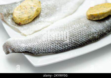 Prepared for fry boneless sea bass fillets with a lemon and pepper ...