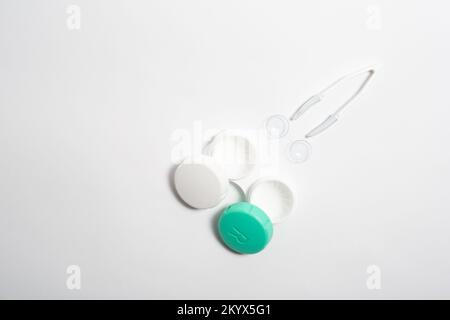 Contact lenses, tweezers and lens storage container on the table Stock ...