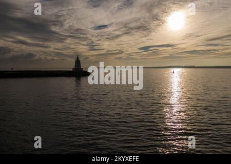 Sunset casting a reflection across the water by the pier at Hartlepool ...