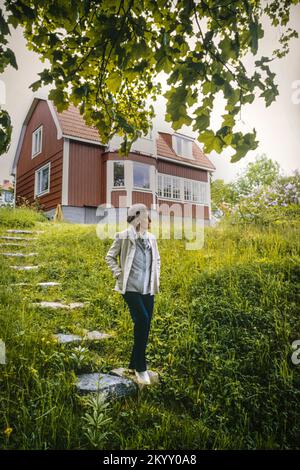 Astrid Lindgren, children's author outside her summer house in Furusund ...