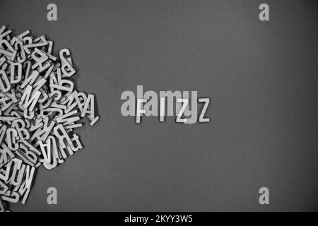 pile of wooden English language capital letters spilling into words ...