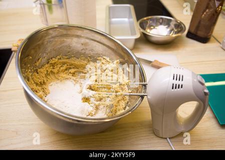 electric hand mixer kneads dough in a deep metal bowl Stock Photo - Alamy