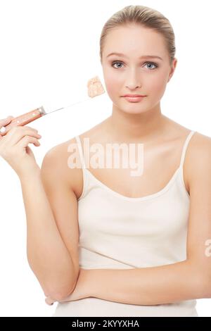 You really look stunning. a young woman applying makeup in front of a ...