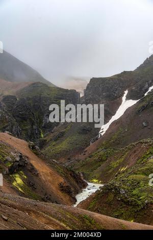 River in a gorge, foot of Asgardsa, volcanic landscape with black and ...