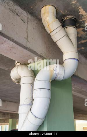 Destin, Florida- White PVC drain pipes view from below on a parking ...