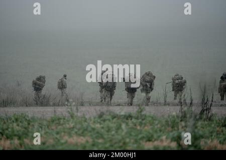 army soldiers on a military tabbing exercise with 40Kg bergen and anti ...