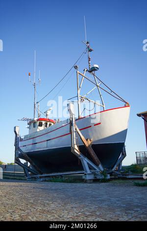 Old fishing boat parked near wooden pier Stock Photo - Alamy