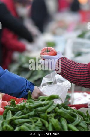 BAZHOU, CHINA - DECEMBER 3, 2022 - People shop at a market in Bazhou ...