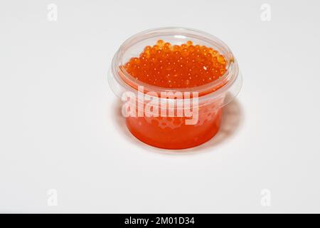 Yellow caviar in a jar, on a white background close-up Stock Photo - Alamy