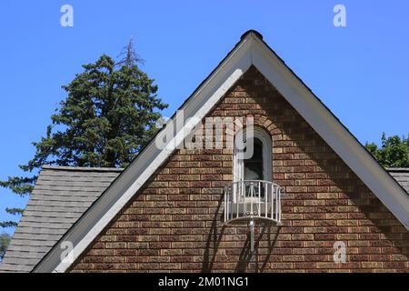 Pointed rooftop of a traditional vintage colonial brick home and ...