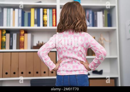 Adorable hispanic girl holding notebook sitting on sofa by christmas ...