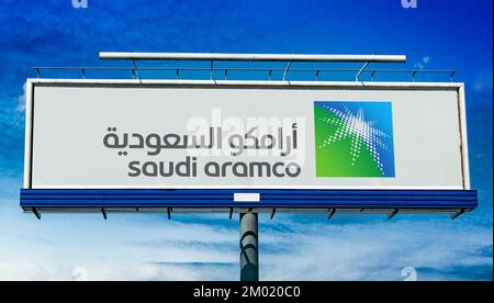 Saudi Aramco company logo on a white screen and finger pointing at it ...
