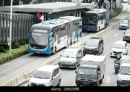 Trans Jakarta Double Decker bus in bus way line, at the rush hour ...