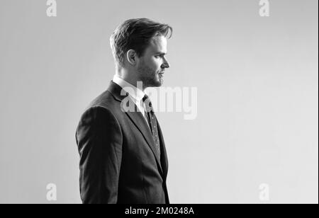 Treat him seriously. Serious guy stand sideway. Guy in formalwear grey ...