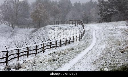 Wooden fence covered with a thin layer of the first snow. Rural ...