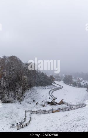Wooden fence covered with a thin layer of the first snow. Rural ...
