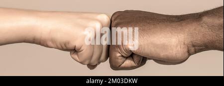 Closeup of multicultural friends giving fist bump to each other. Black ...