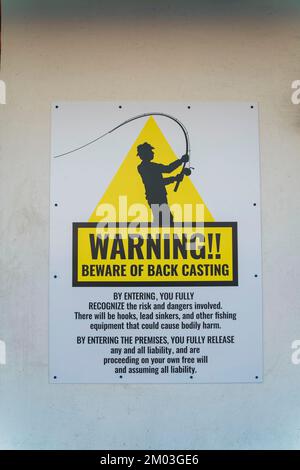 Destin, Florida- Sign on a wall with Warning Beware of Back Casting ...