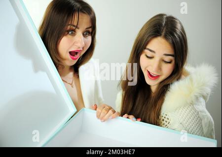 Mom and daughter look into Pale blue big boxes are surprised have fun ...